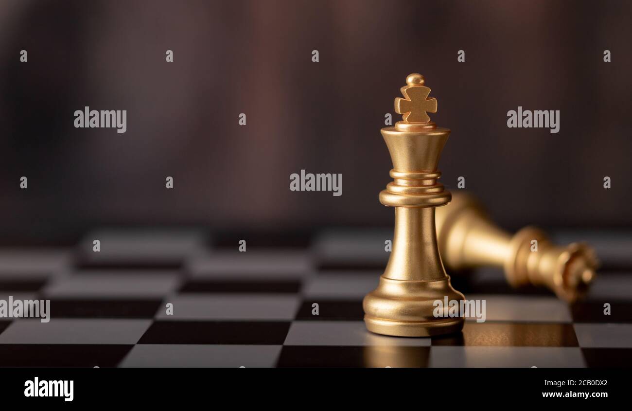 gold king standing and queen falling in game on chess board Stock Photo ...