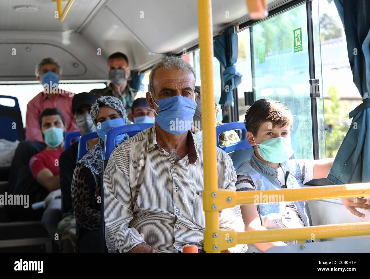 Damascus, Syria. 9th Aug, 2020. Syrians wearing facial masks take ...
