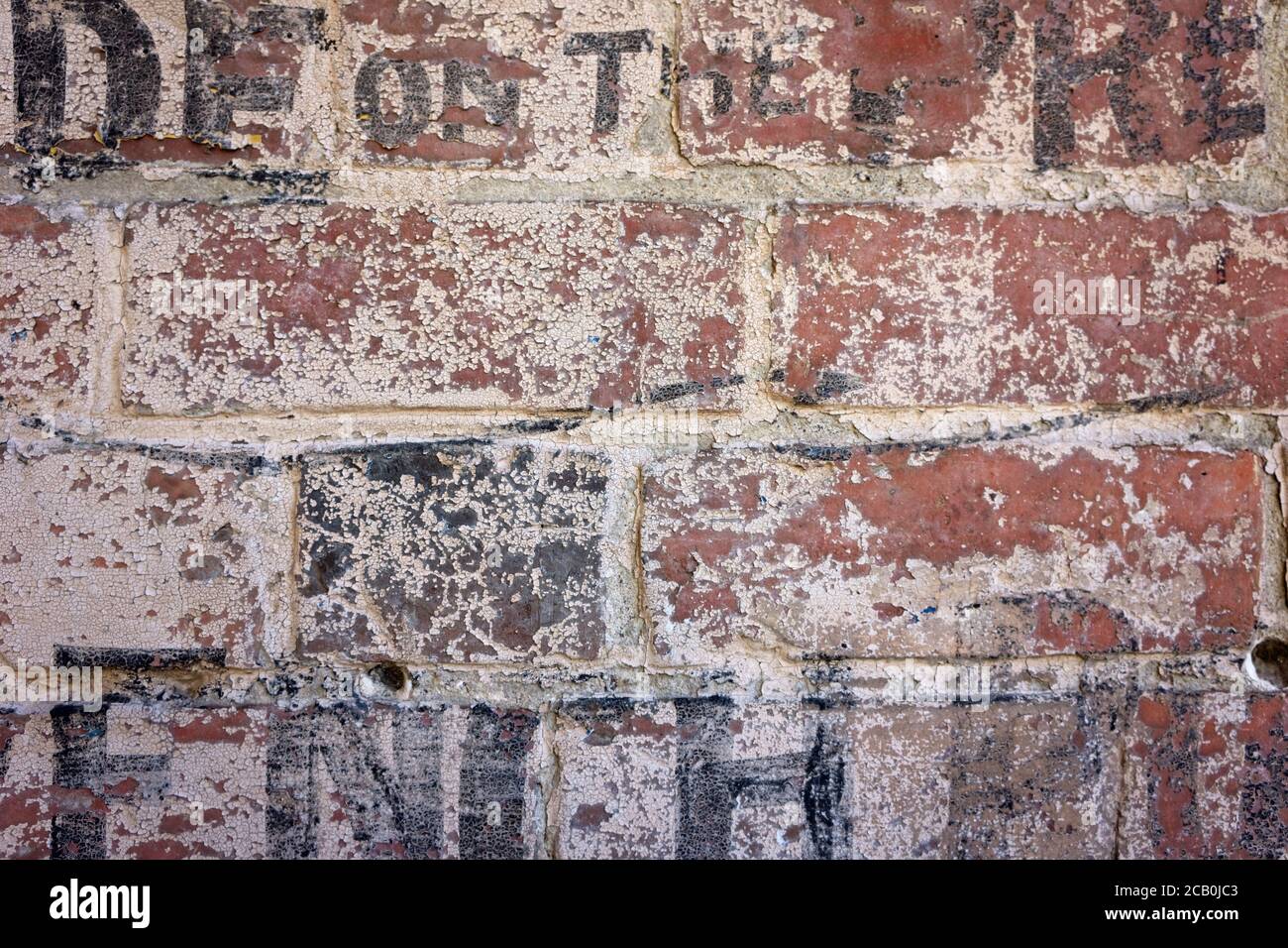 Vintage brick wall background and abstract typographic design font with ...