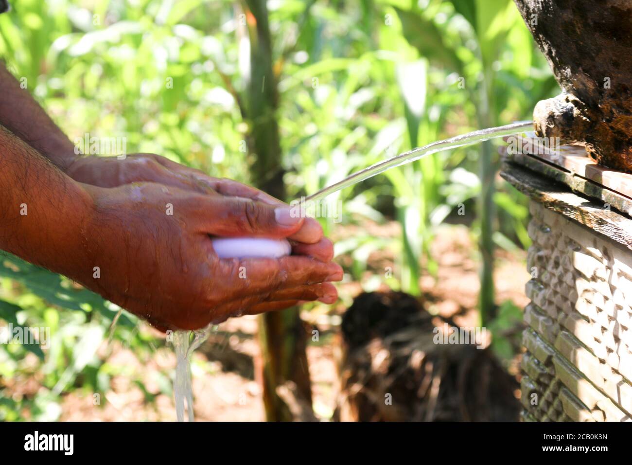 Old man washing hands water hi-res stock photography and images - Alamy