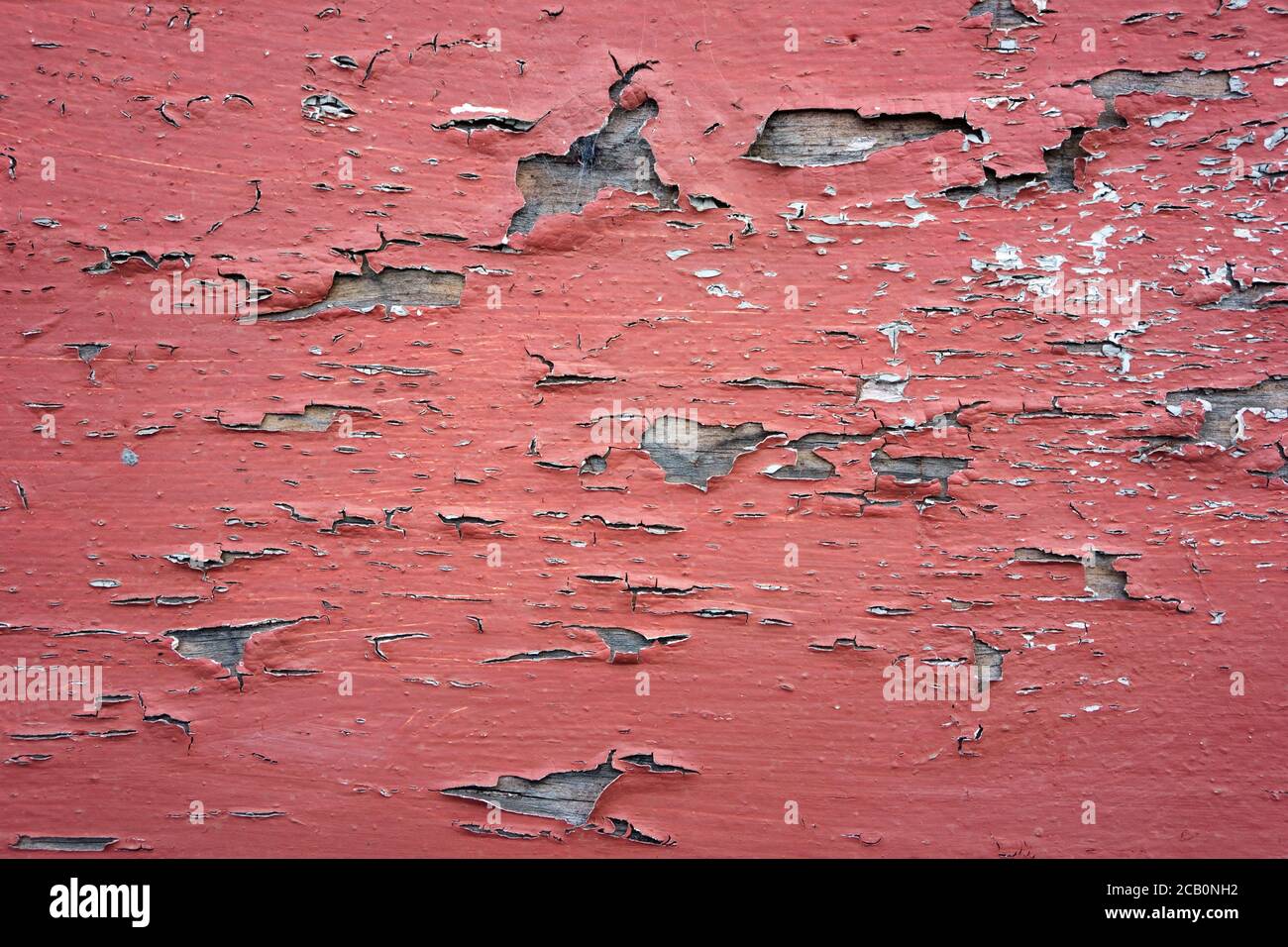 Abstract red texture background with peeling paint close up and mottled ...