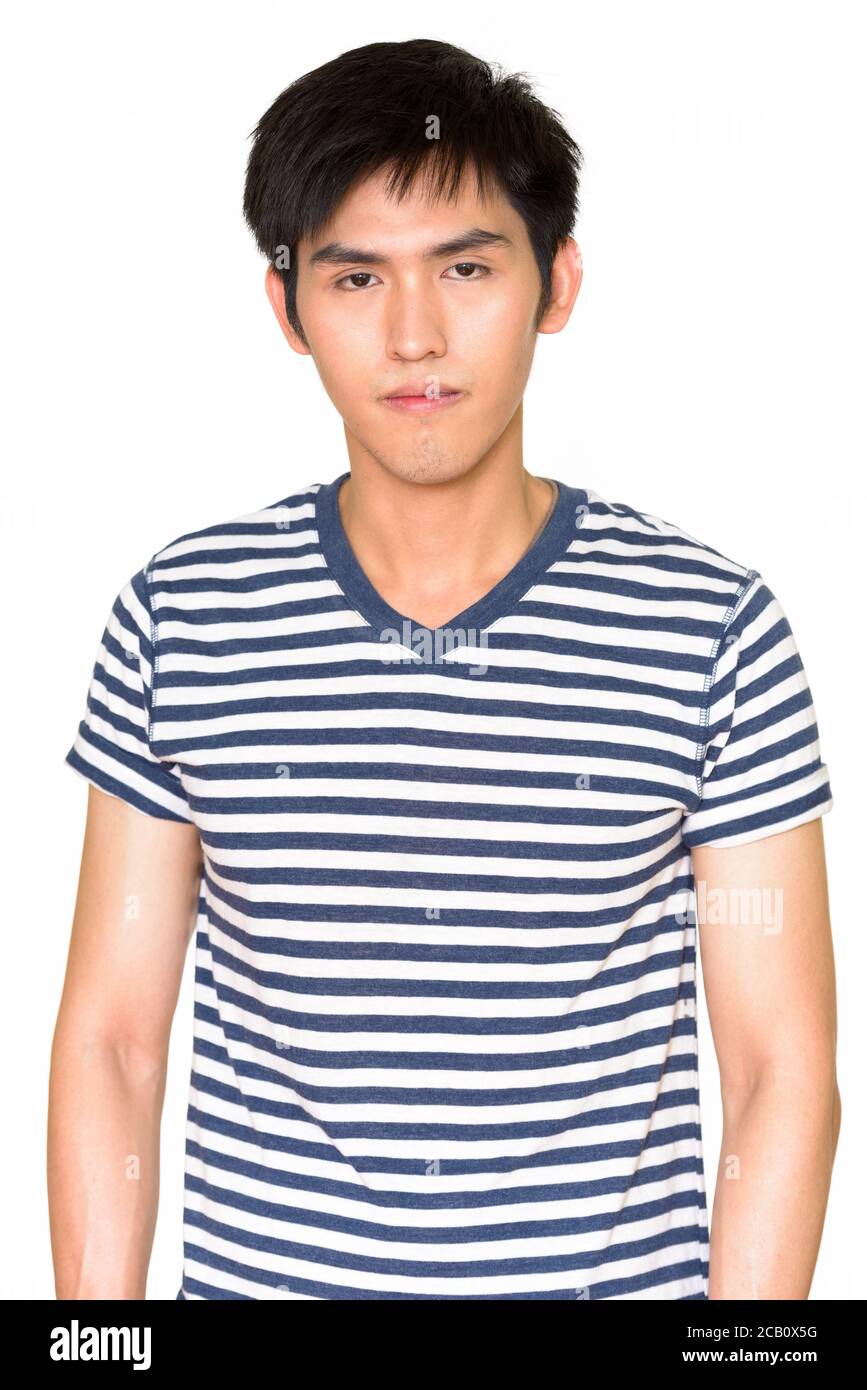 Studio shot of young handsome Asian man against white background Stock ...