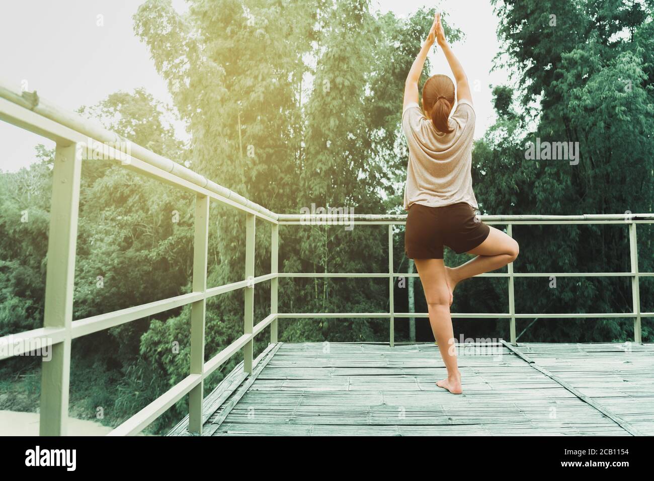 Woman doing yoga exercise in the morning with natural backgroung Stock ...