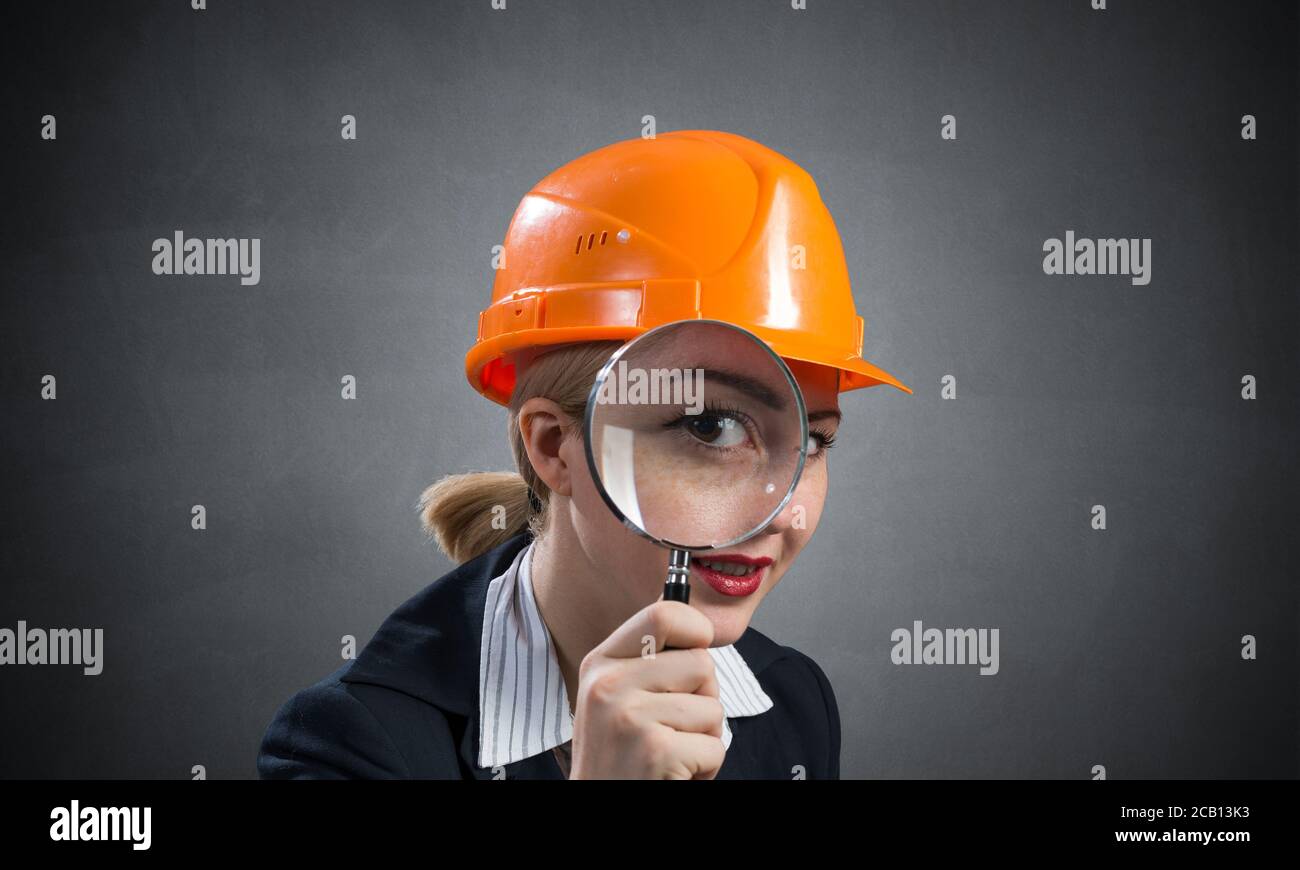 Technical inspector looking through magnifier Stock Photo - Alamy
