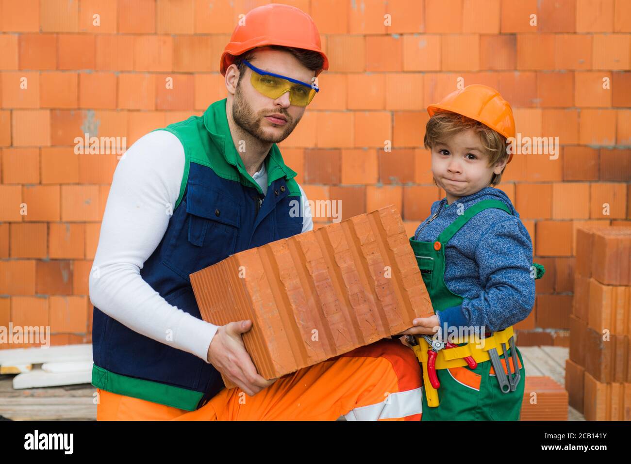 Brothers bricklayers make masonry, builders work with brick layer Stock ...