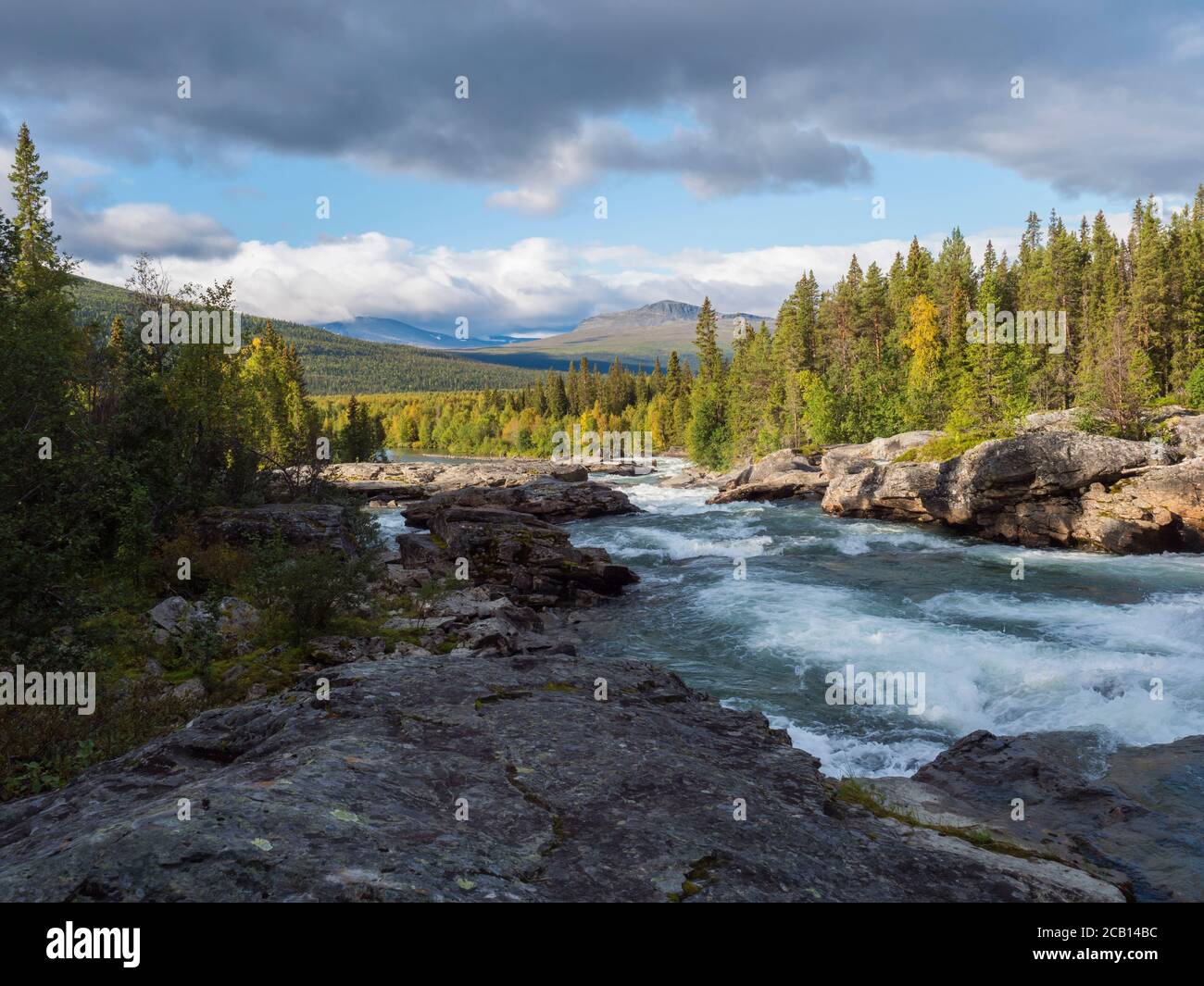 Beautiful northern landscape with wild glacier river Kamajokk, boulders ...