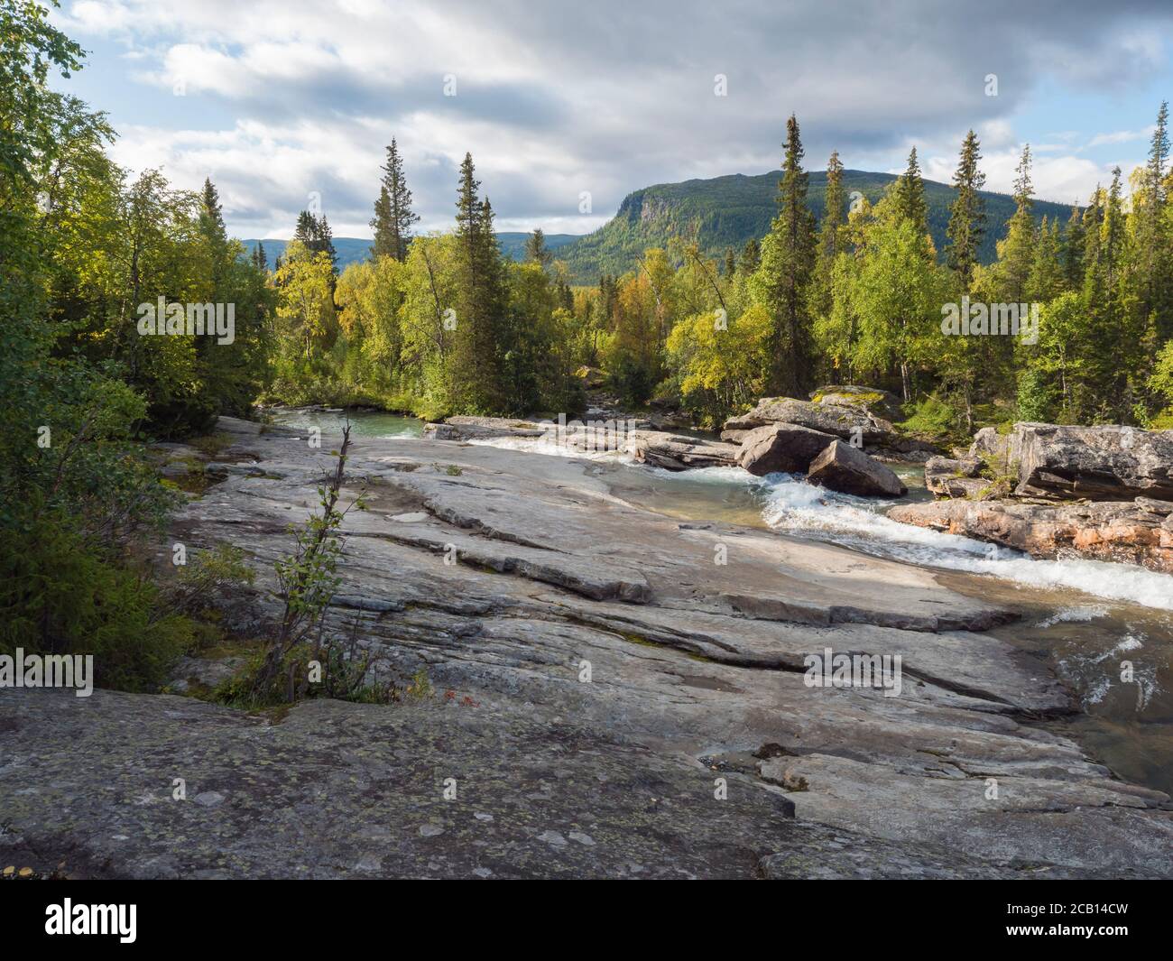 Beautiful northern landscape with wild glacier river Kamajokk, boulders ...