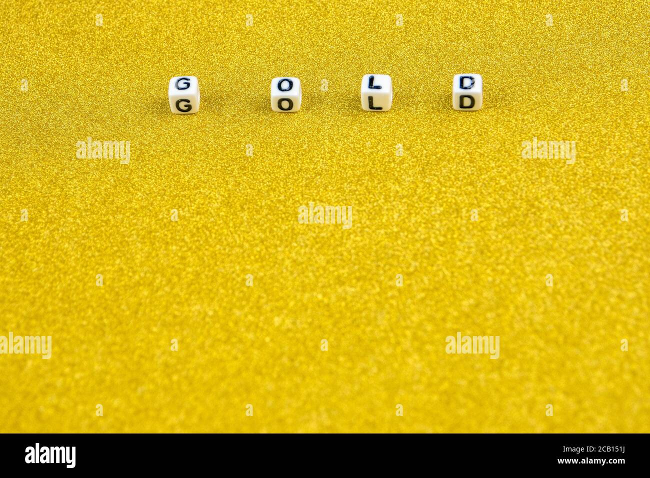 gold word formed by white dices with black letters laying in upper part ...