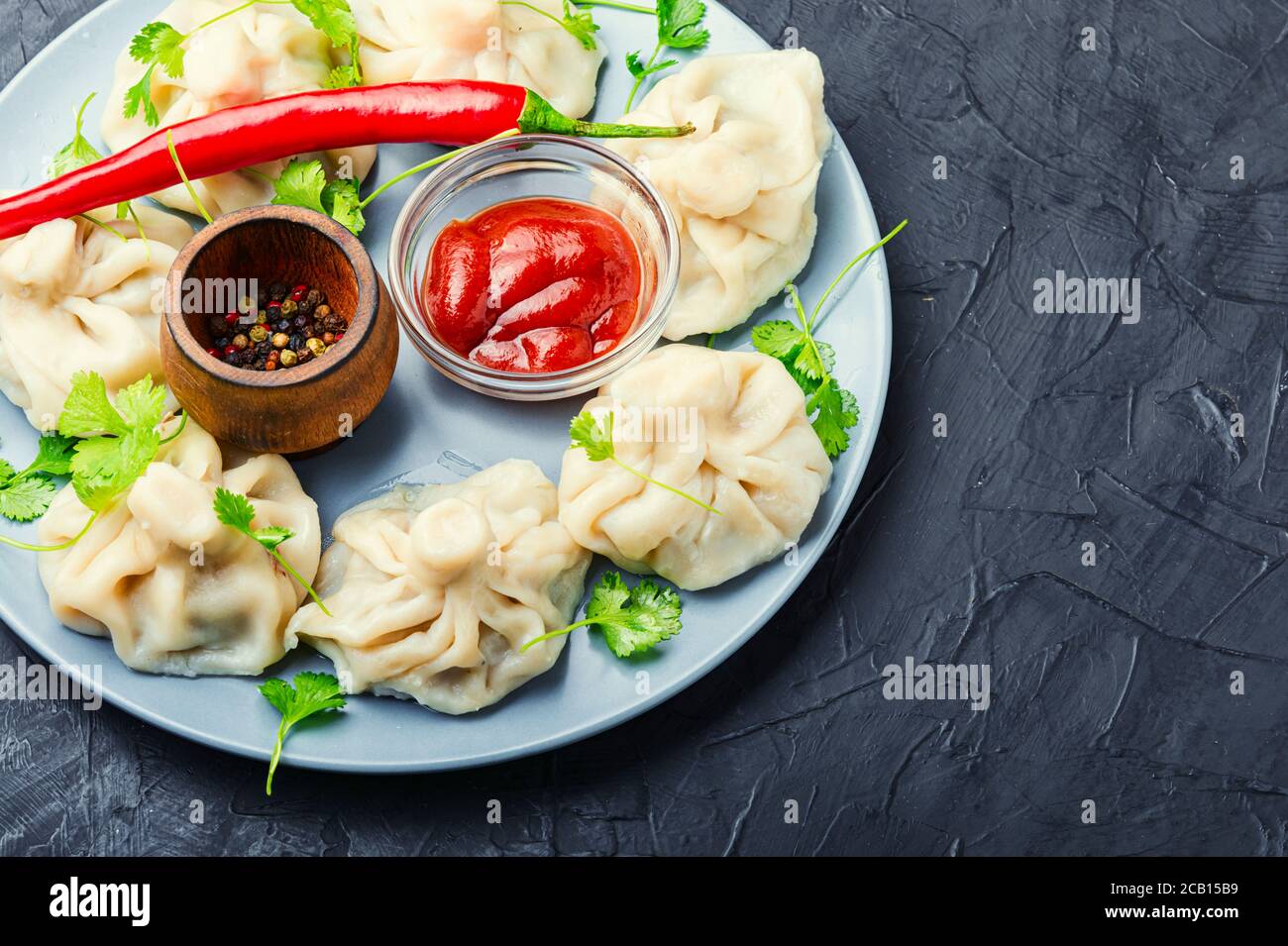 Georgian dumplings khinkali with meat, greens and tomato sauce Stock ...