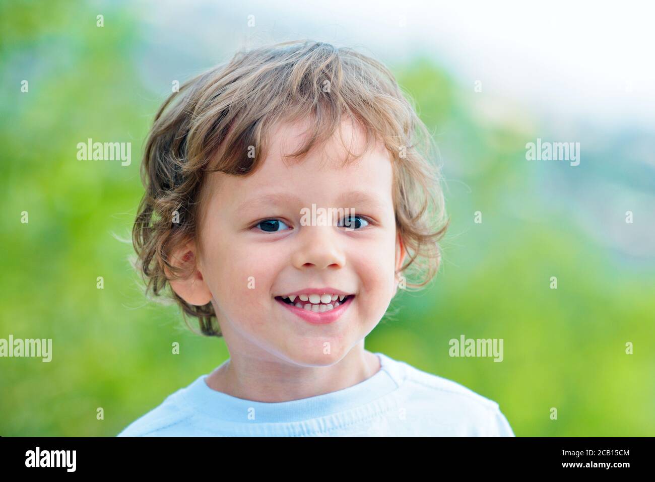 Emotional kid walks outdoors and enjoy walking. Portrait of a boy ...