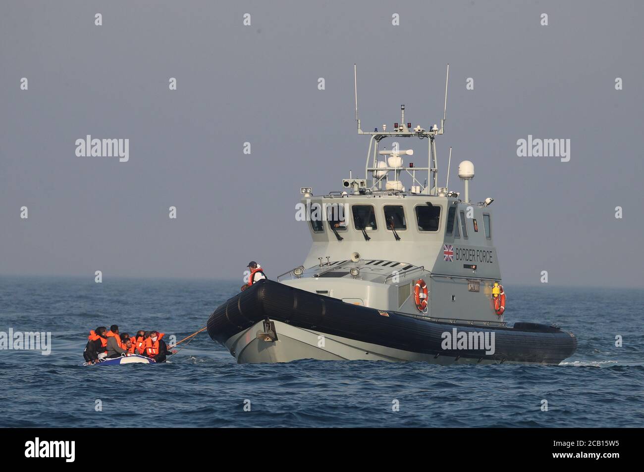 Border Force officers aboard HMC Hunter speak to group of people ...