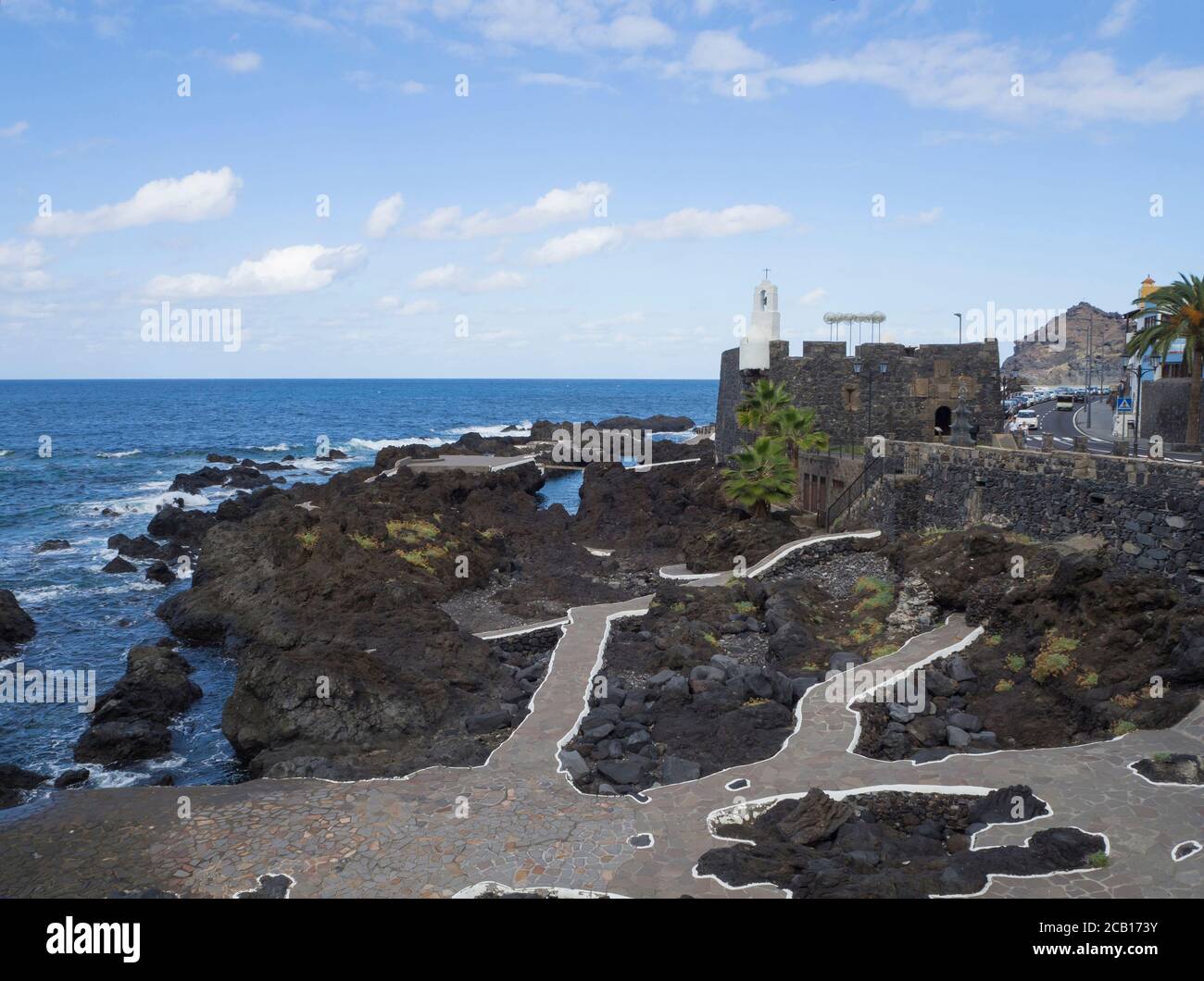 View on village Garachico with sea pools and lava rocks and main road ...
