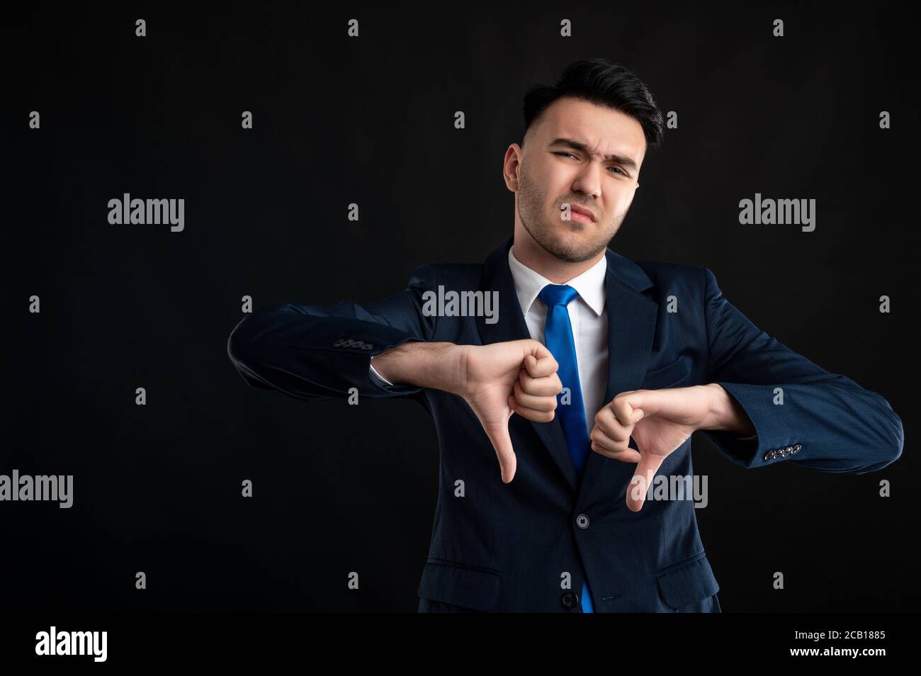 Portrait of business man wearing blue business suit and tie showing ...
