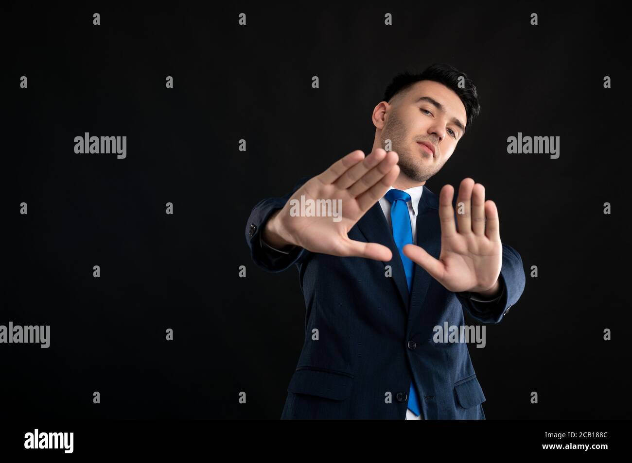 Portrait of business man wearing blue business suit and tie showing ...