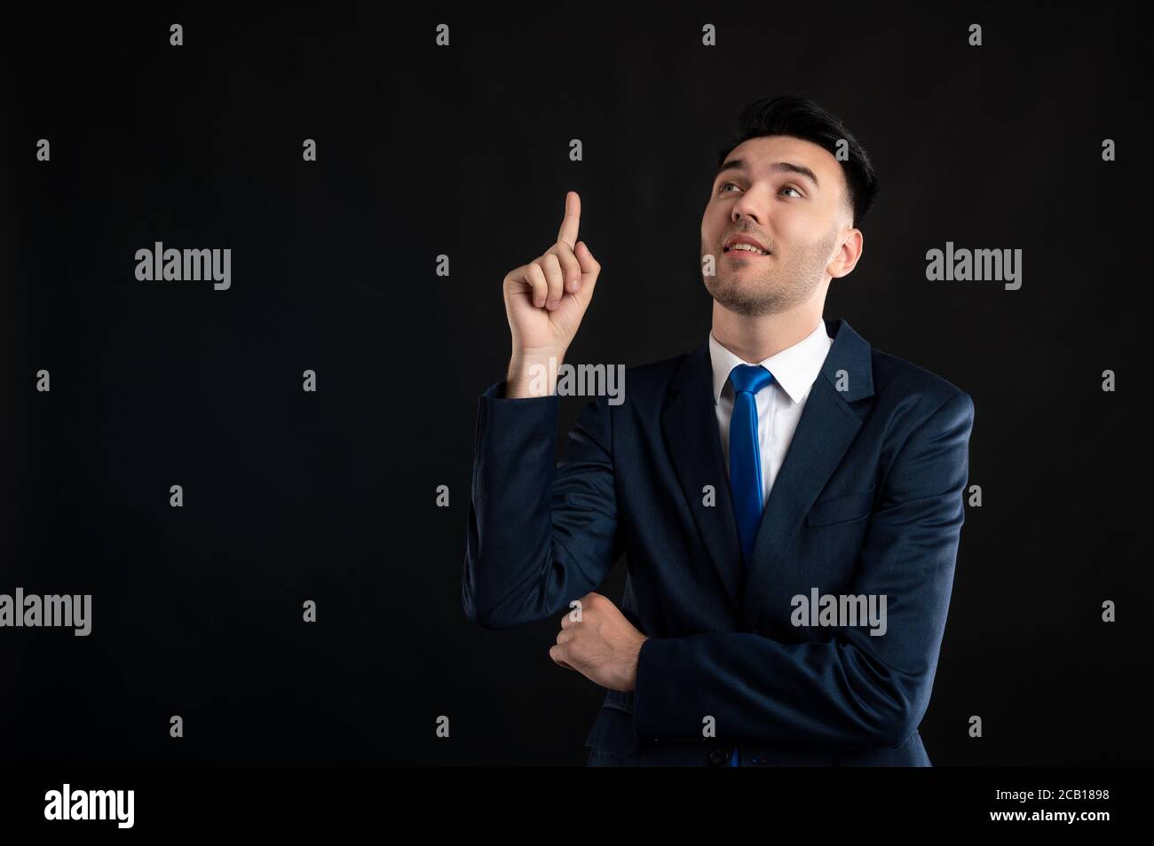 Portrait of business man wearing blue business suit and tie he thinks ...