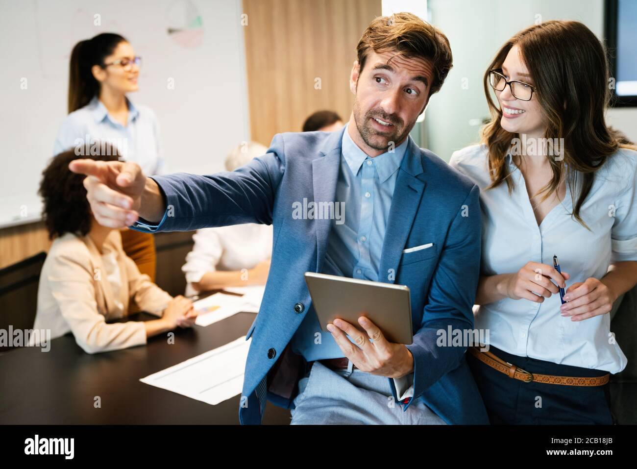 Business colleagues in conference meeting room during presentation ...