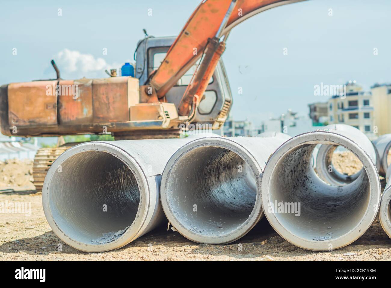 Stack of concrete drainage pipes for wells water discharges laying an ...