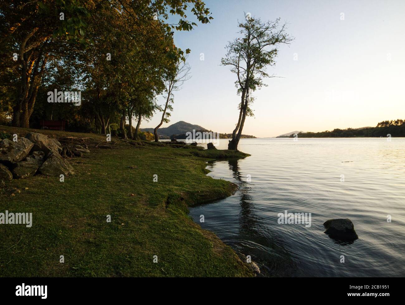 Beautiful shot of a lakeshore landscape on a clear sky background Stock ...