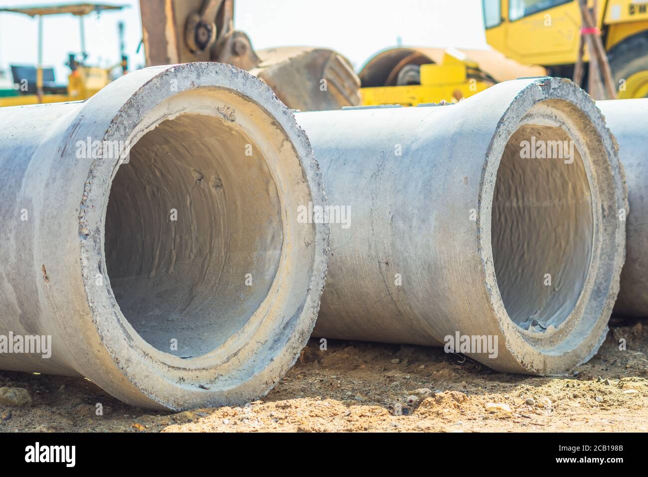 Stack of concrete drainage pipes for wells water discharges laying an ...