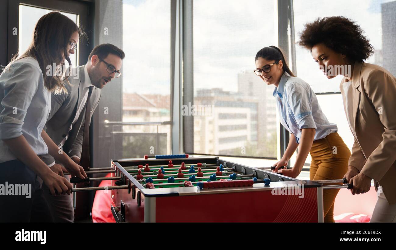 Colleagues playing table football in the break Stock Photo - Alamy
