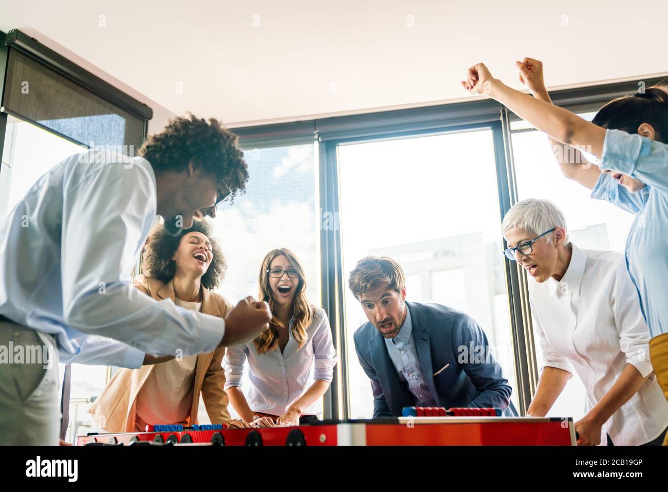 Business people having great time together.Colleagues playing table ...