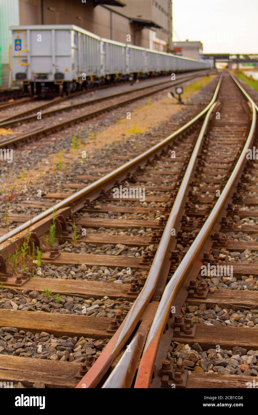 Vertical shot of railroads and a train container Stock Photo - Alamy