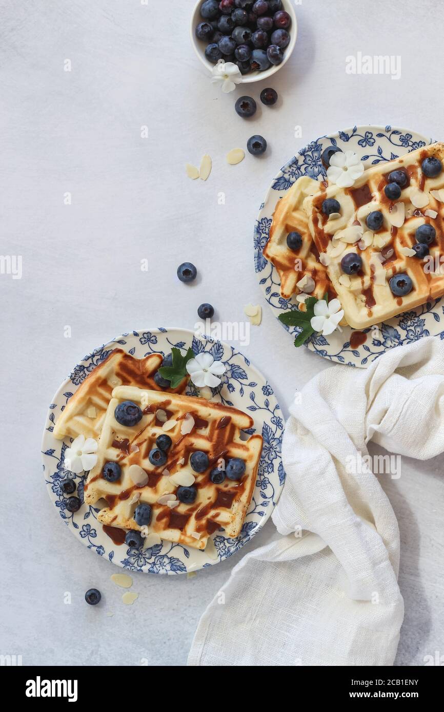 Food flat lay with homemade waffles and blueberries on a grey ...