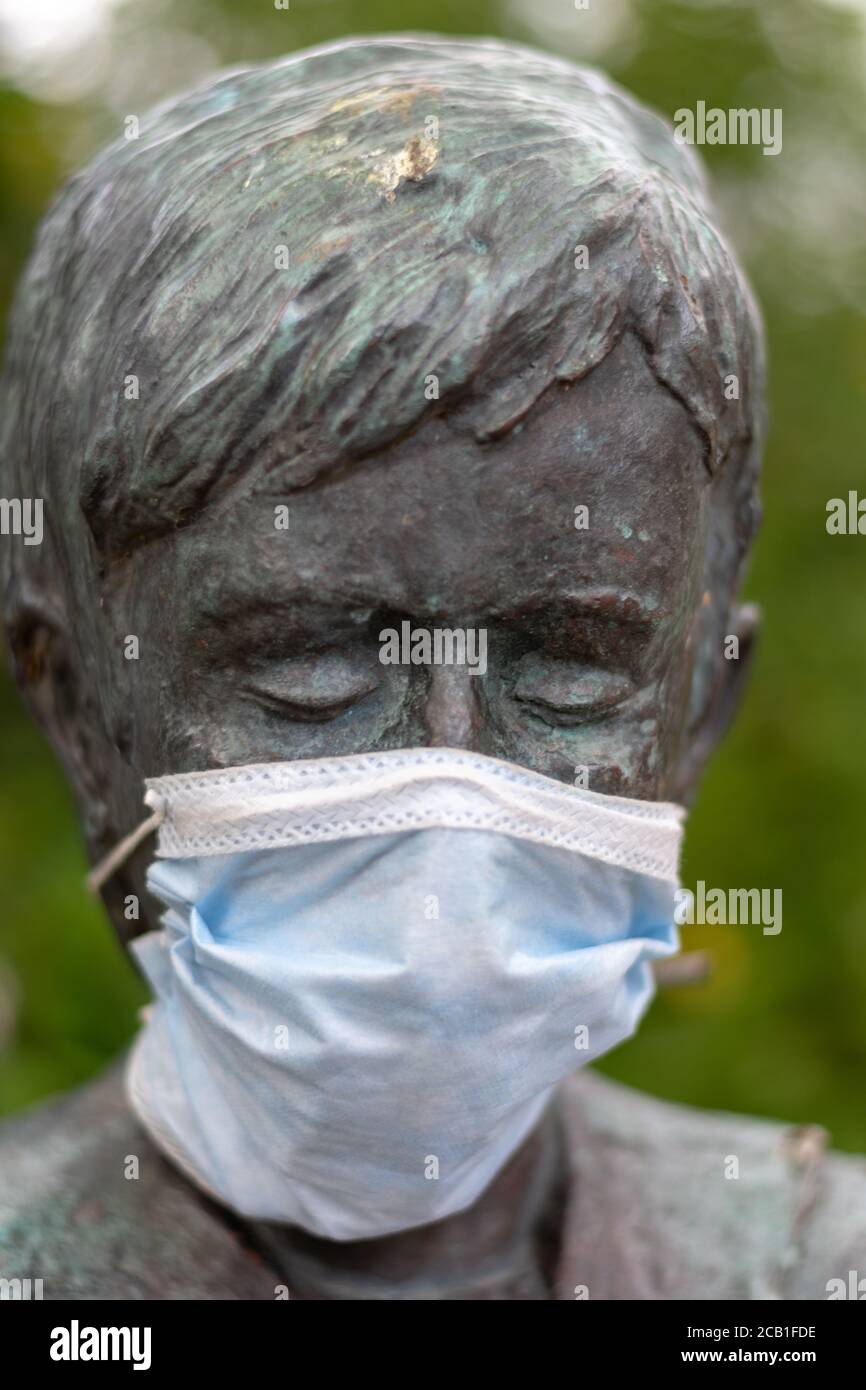 Vertical closeup shot of a statue wearing a medical face mask Stock ...