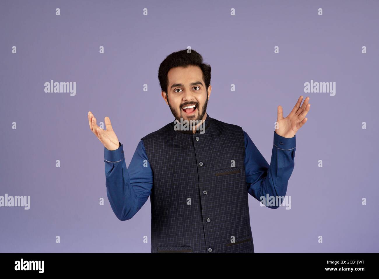 Portrait of excited Indian man expressing joy over lilac background ...