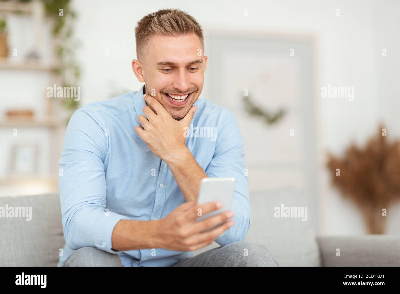 Cheerful guy home using hi-res stock photography and images - Alamy