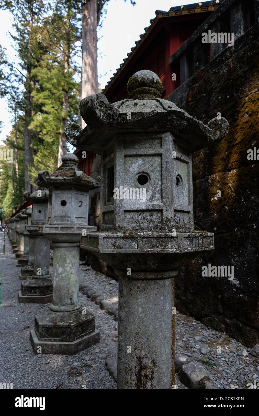 Row of toros or concrete lanterns at a Japanese shrine Stock Photo - Alamy