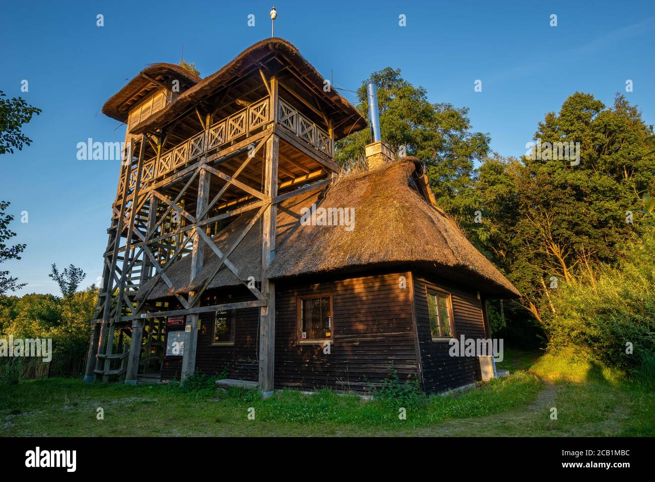 Wooden house with a watchtower by the lake Stock Photo - Alamy