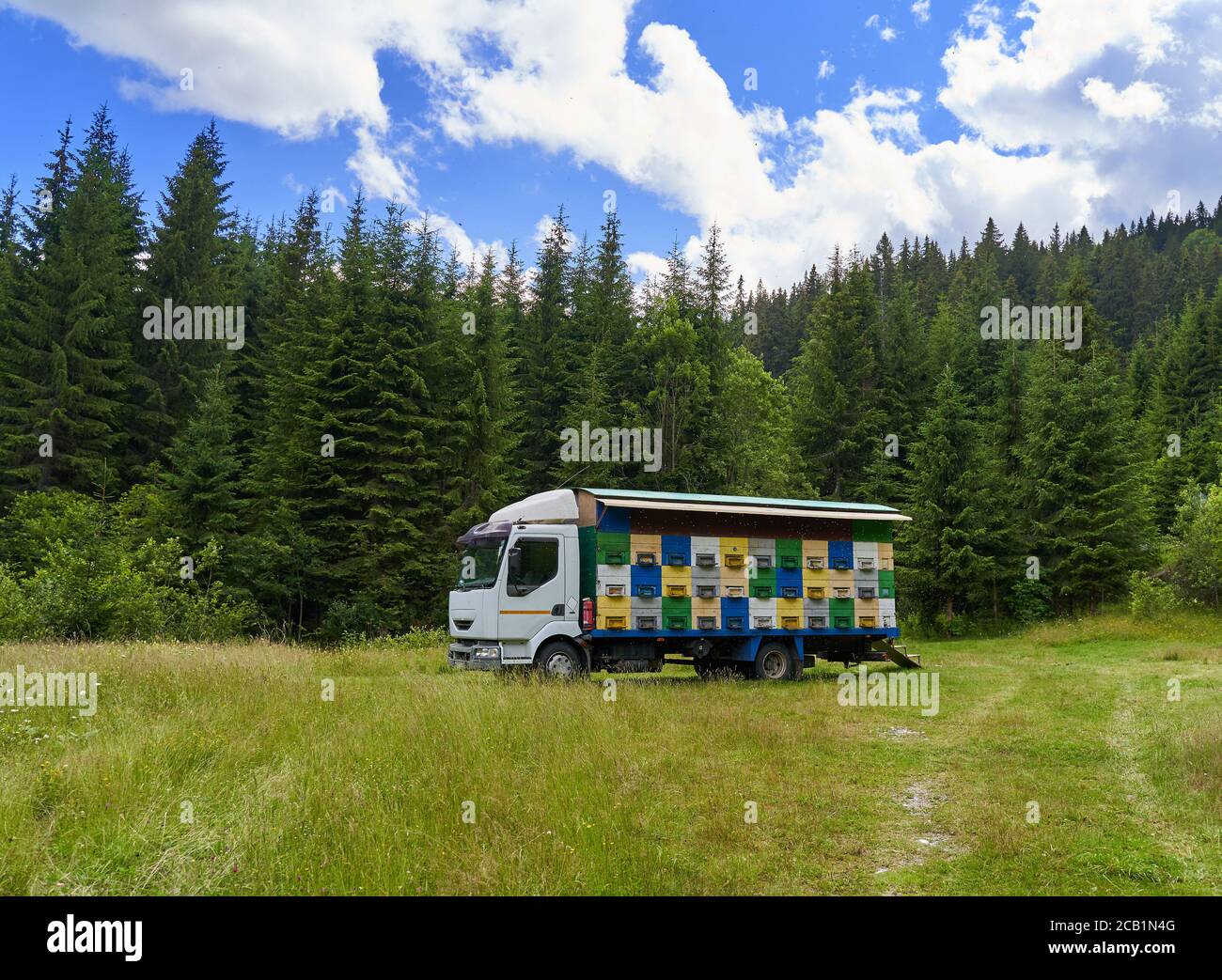 A lorry with bee hives in the mountains Stock Photo - Alamy