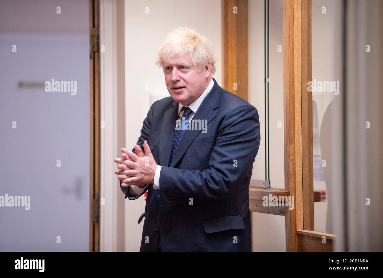Prime Minister Boris Johnson sanitises his hands during his visit to St ...