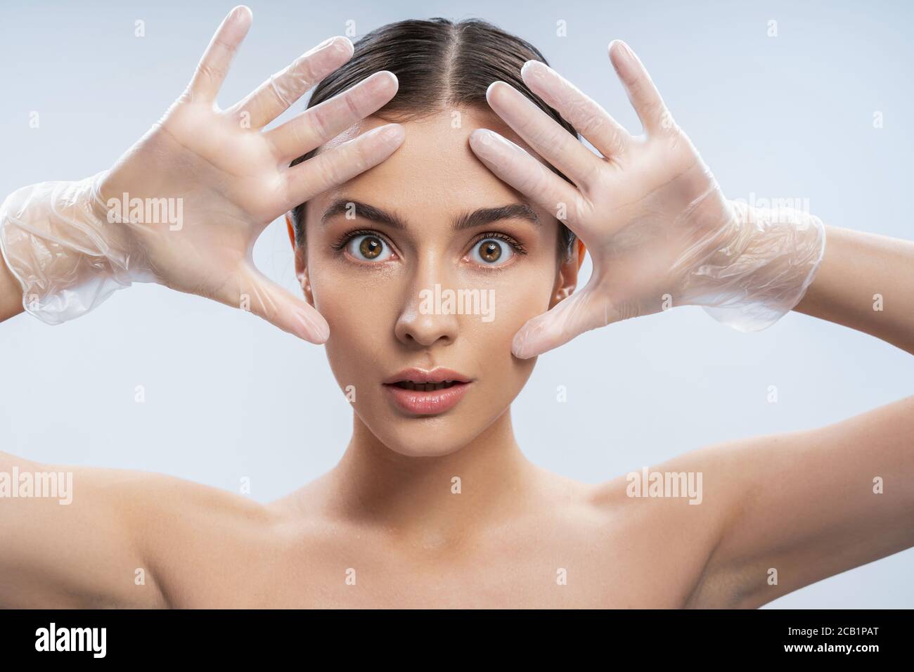 Beautiful young woman wearing transparent disposable gloves Stock Photo ...