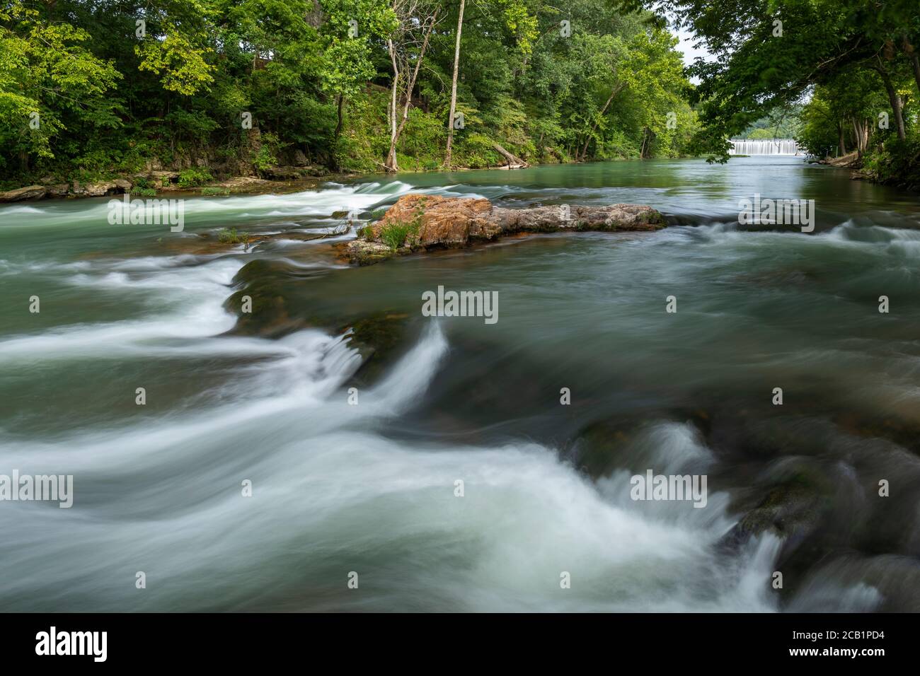 Rapids on the Spring River with a dam in the distance Stock Photo - Alamy