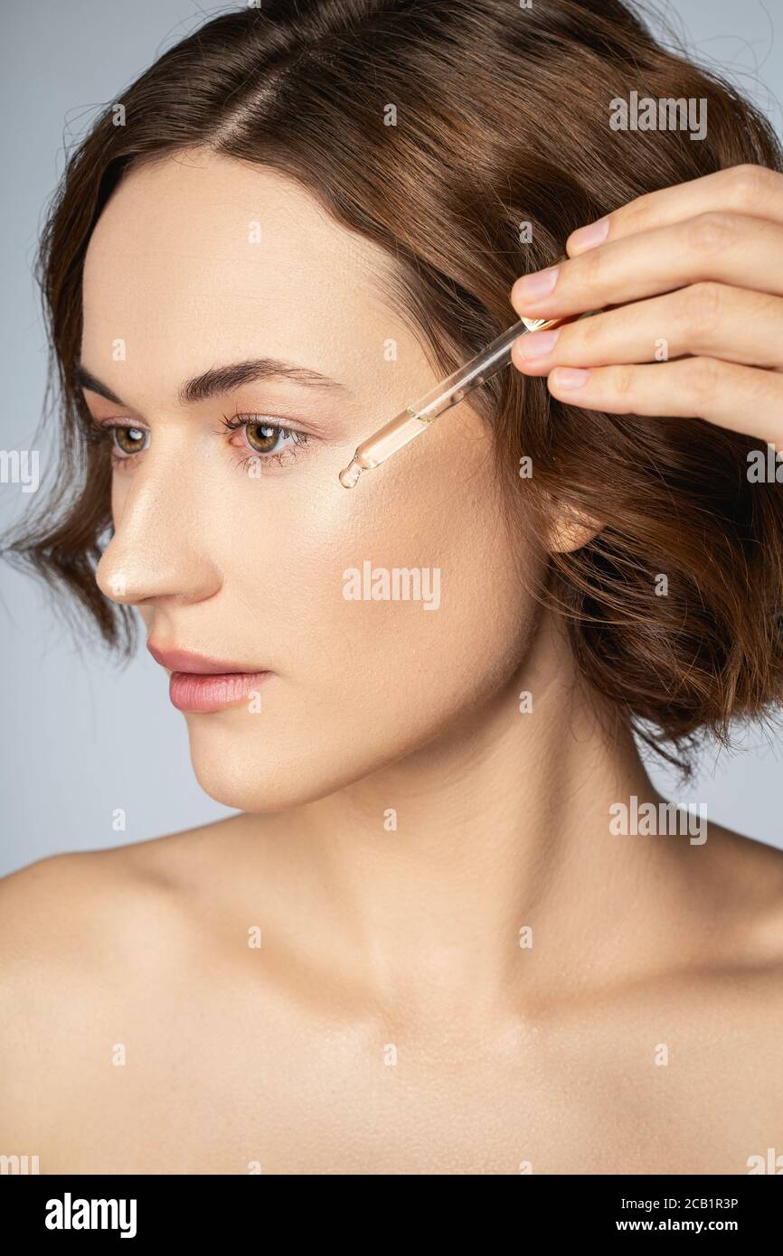 Applying nourishing oil serum hi-res stock photography and images - Alamy
