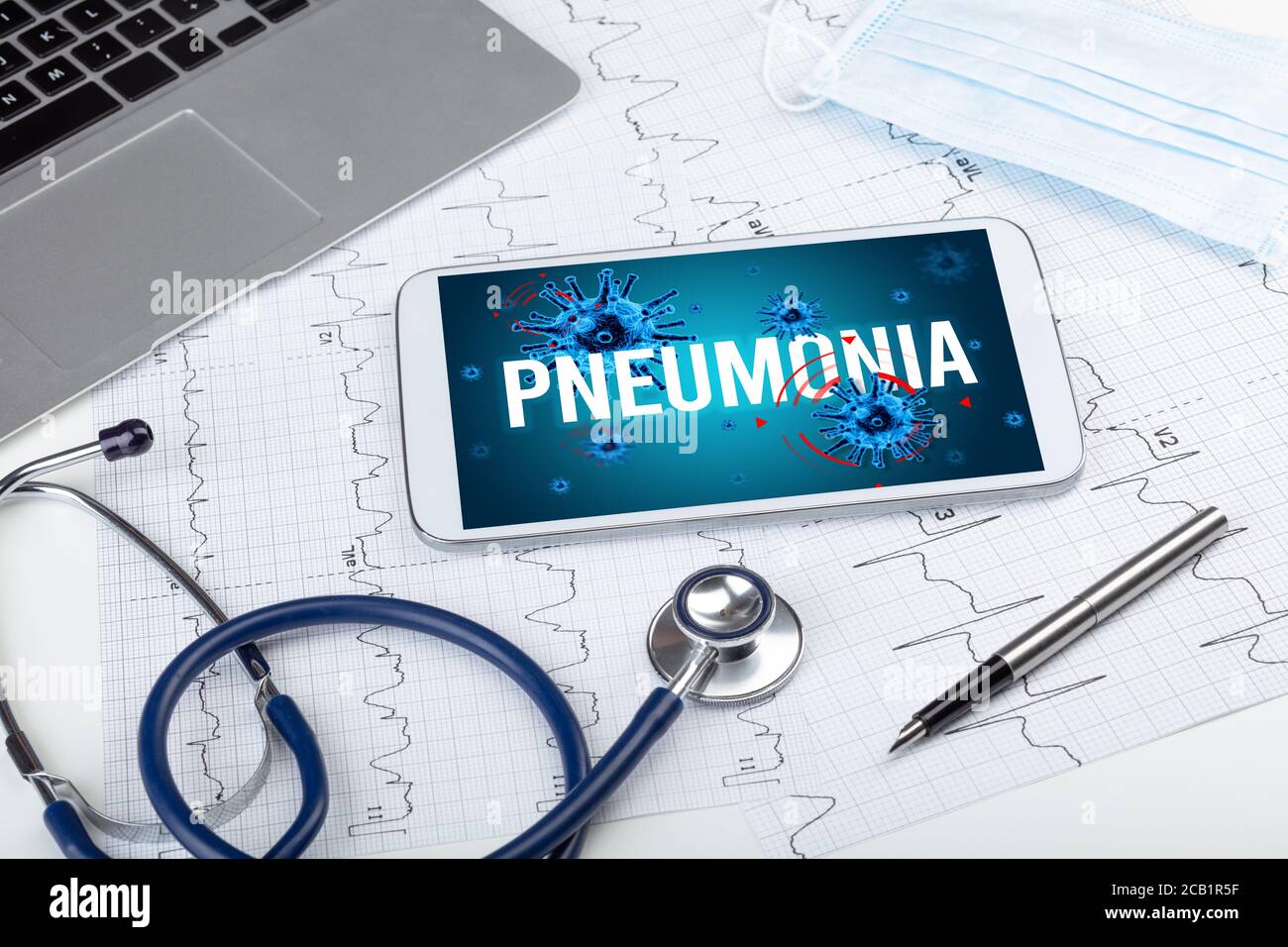 Tablet pc and doctor tools on white surface with PNEUMONIA inscription ...