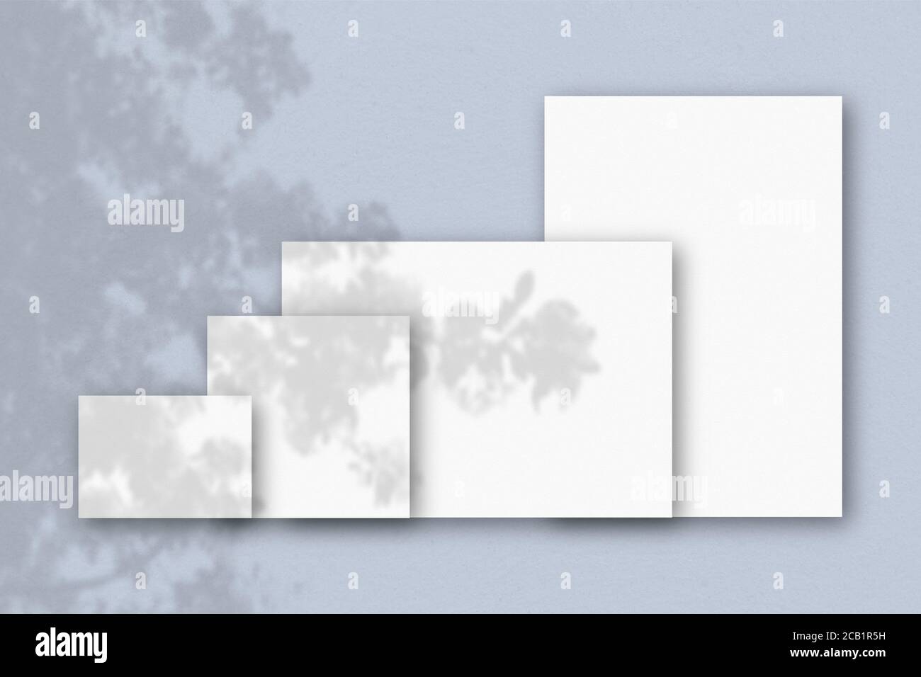 Several horizontal and vertical sheets of white textured paper against ...