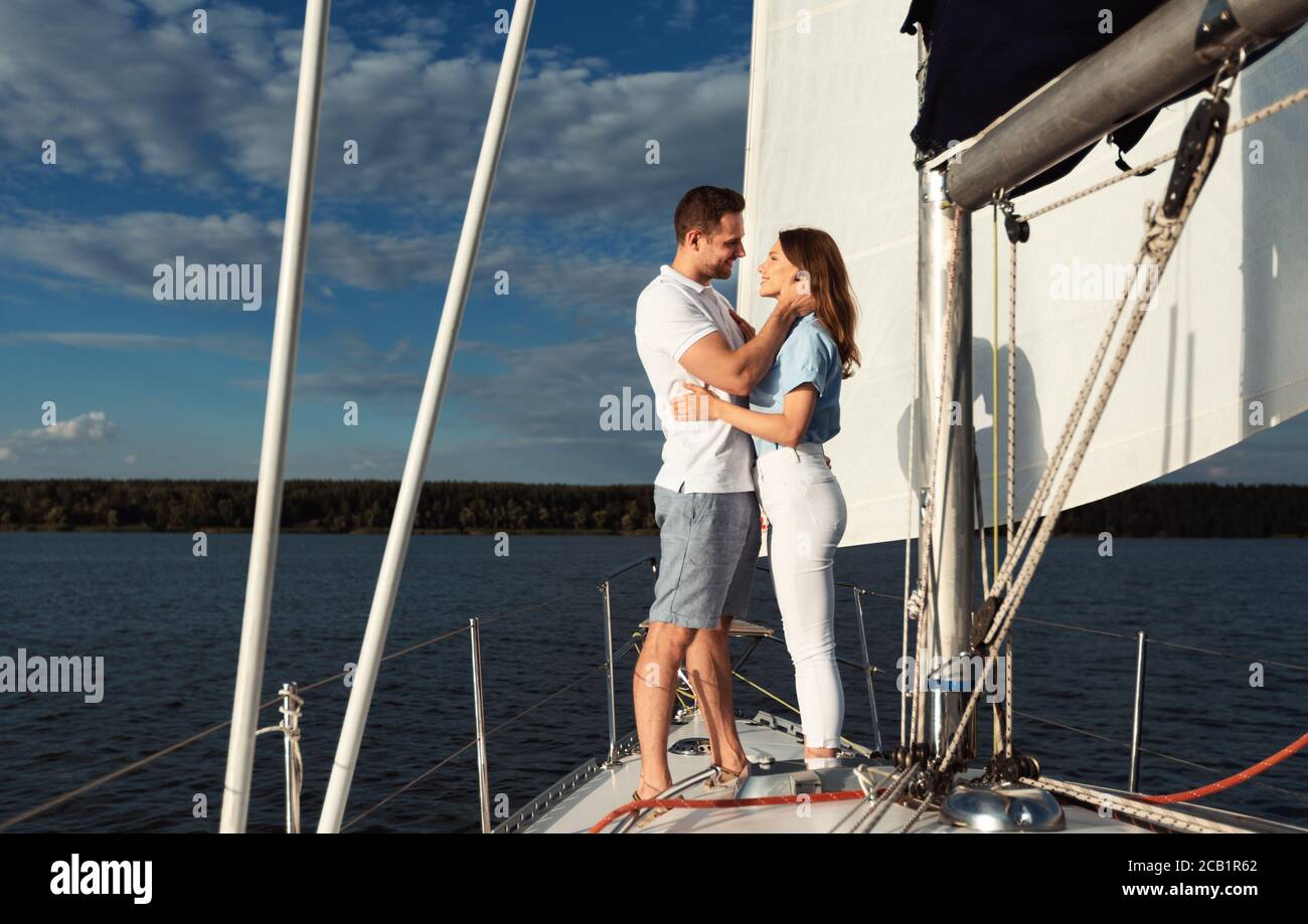 Loving Couple Embracing Standing On Sailboat Sailing On River Outdoor ...