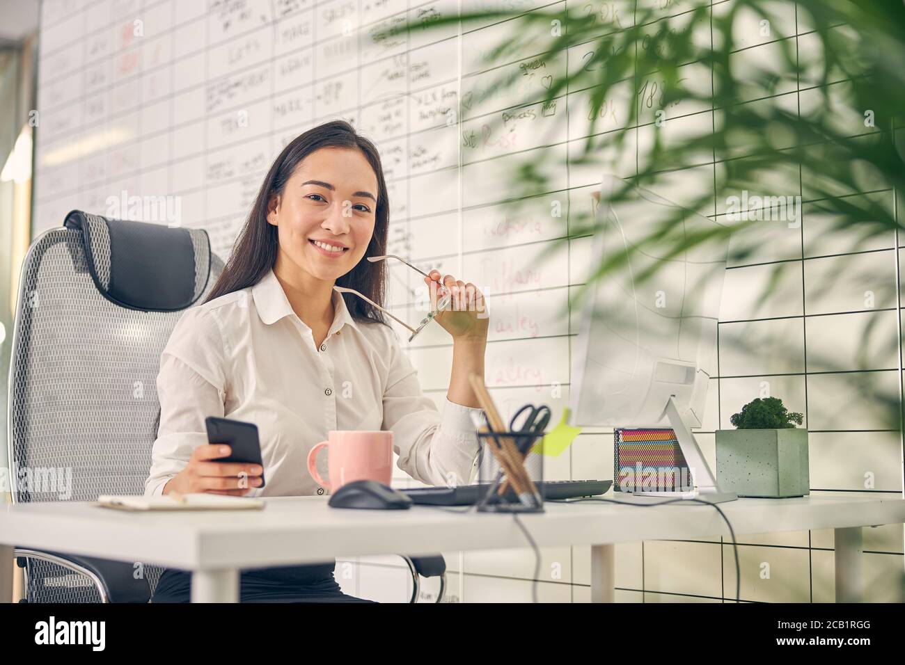 Cheerful brunette female person looking straight at camera Stock Photo ...