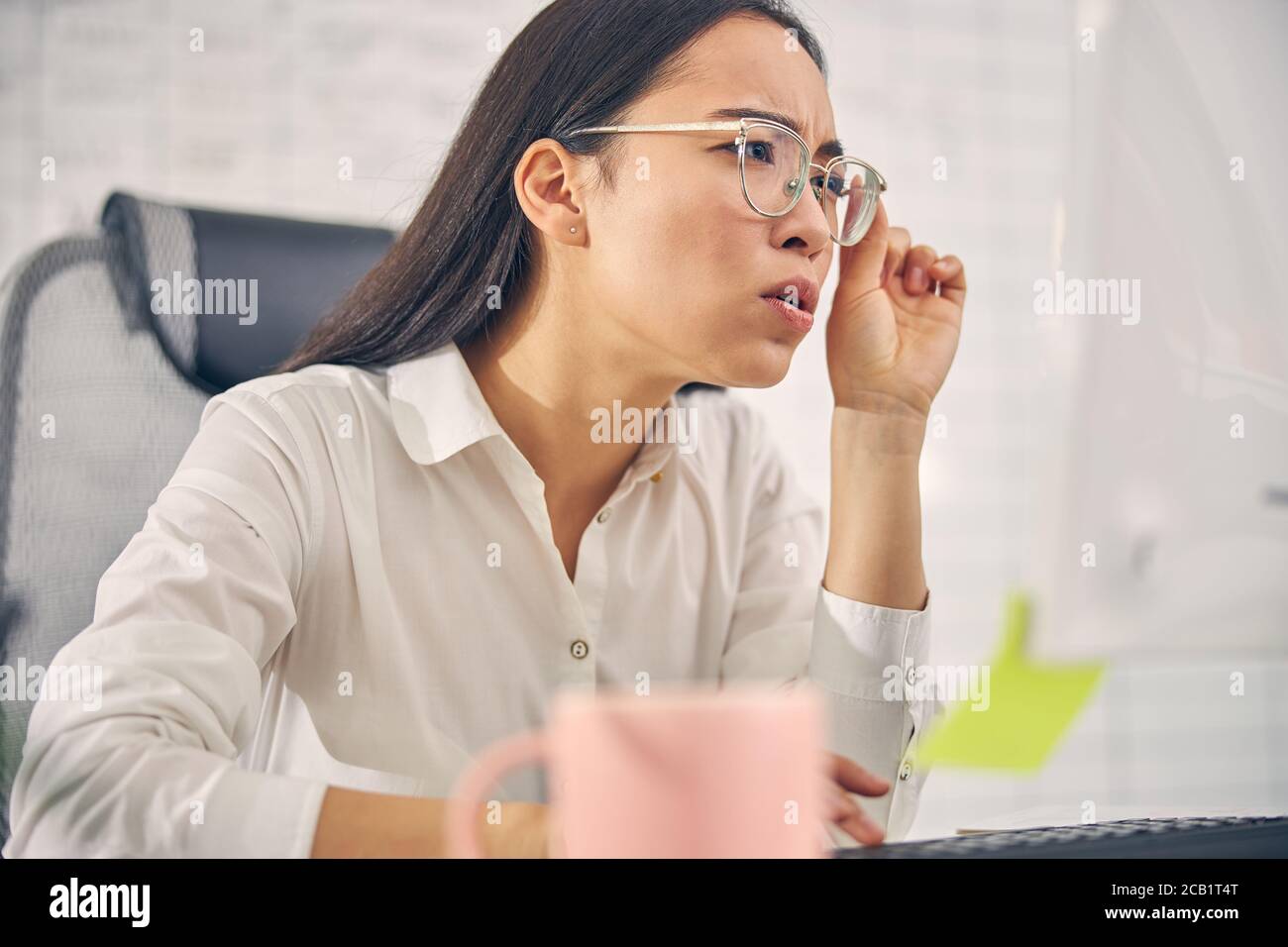 Close up of attentive female staring at computer Stock Photo - Alamy