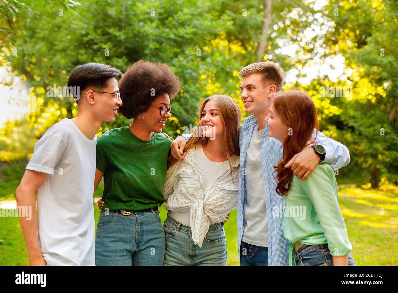 University Friendship. Multiracial students standing together at campus ...