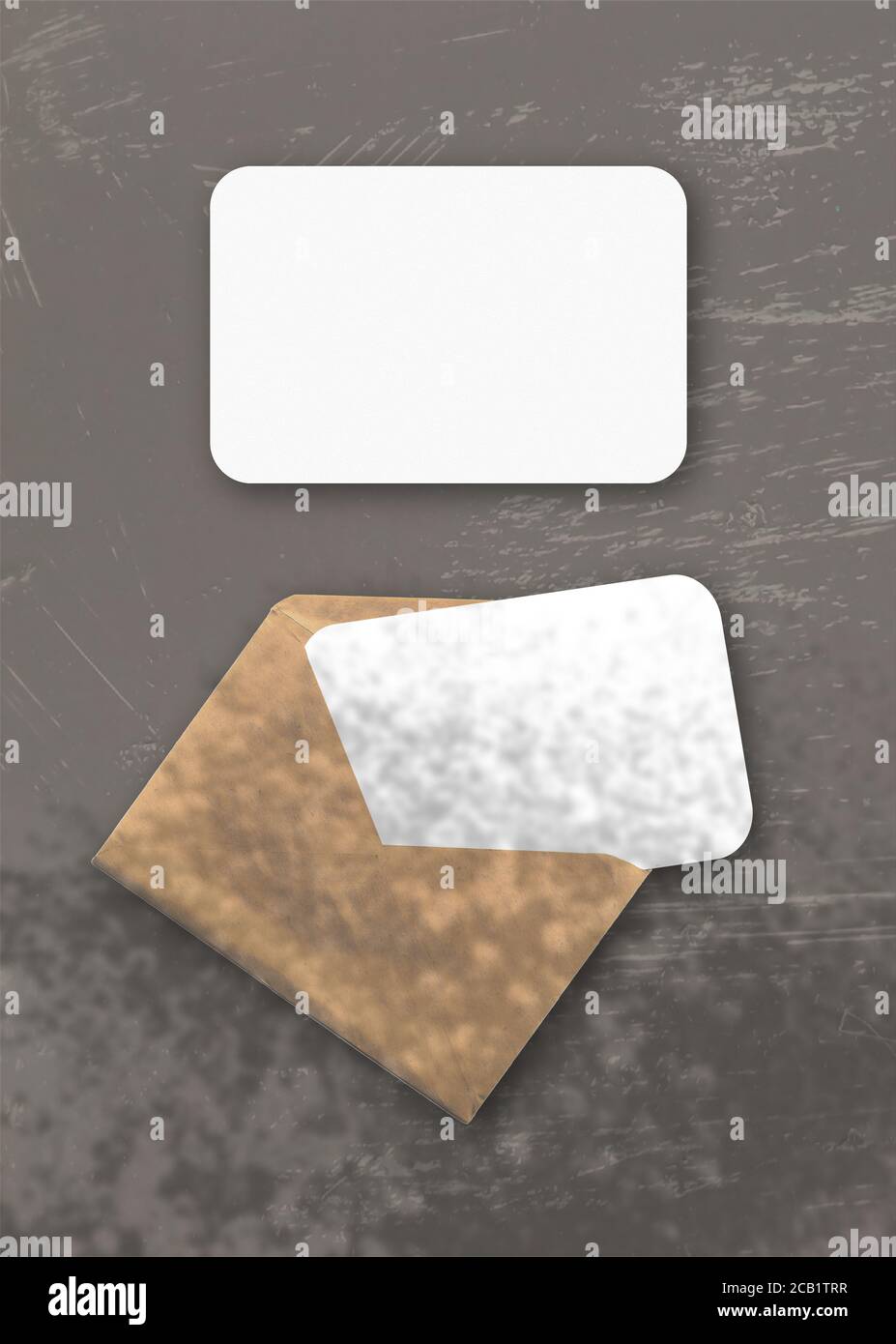 An envelope with two sheets of textured white paper on the grey ...