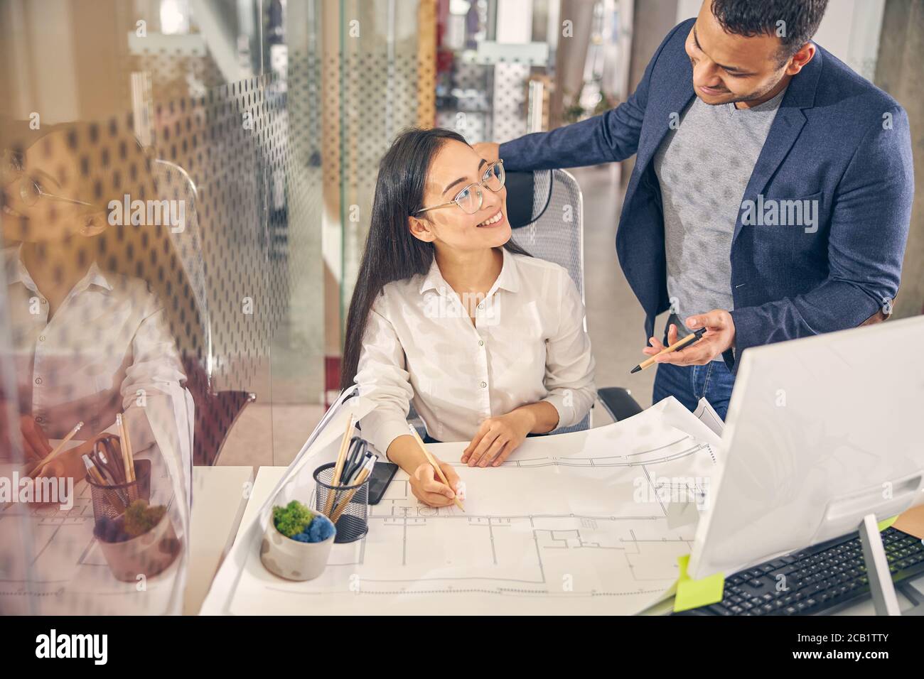 Positive delighted people discussing their new project Stock Photo - Alamy