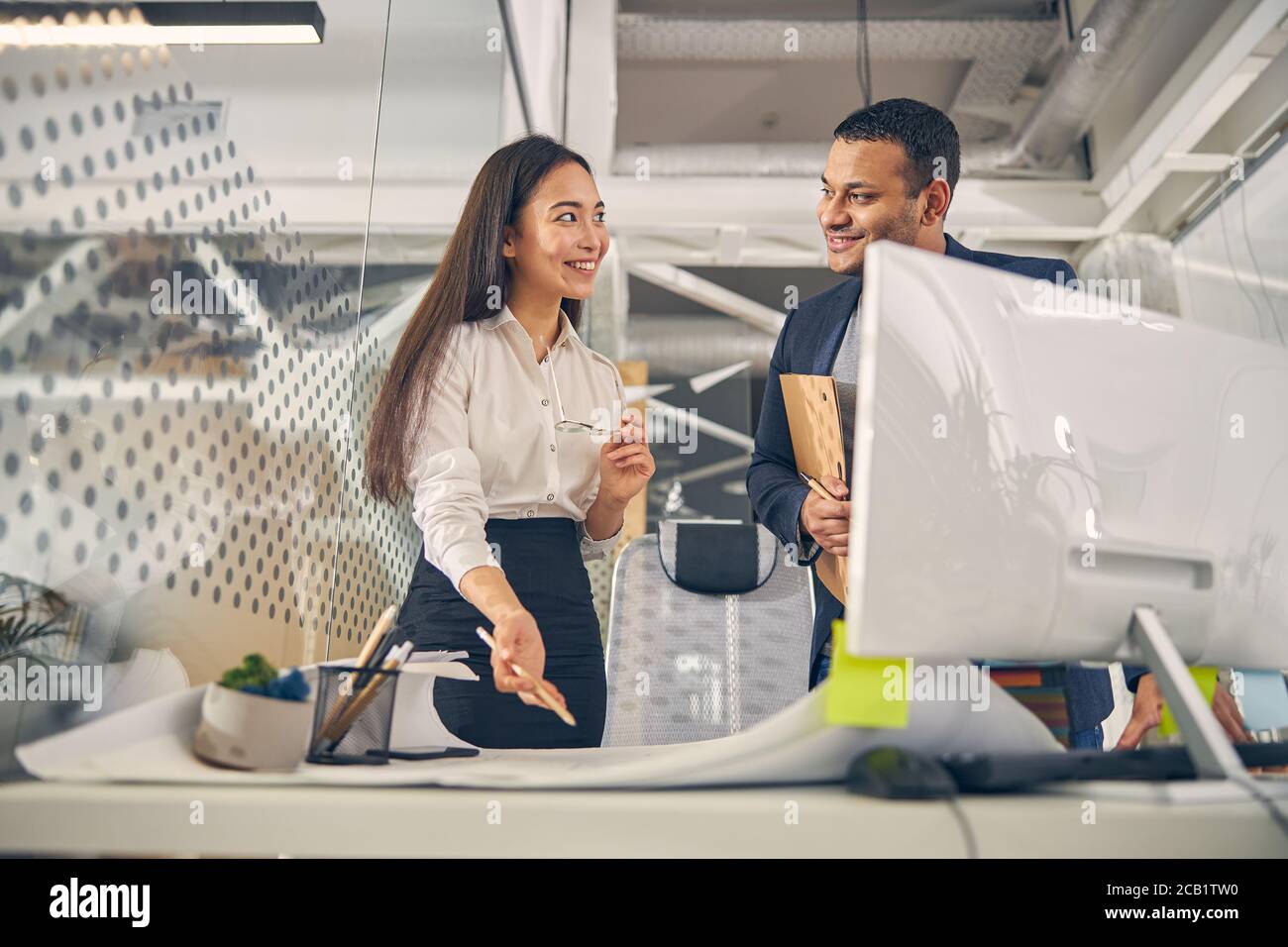 Delighted international people looking at each other Stock Photo - Alamy