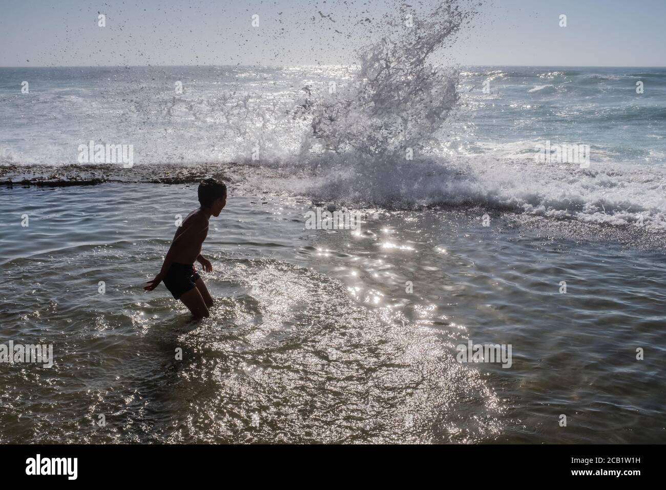 Child on the wave hi-res stock photography and images - Alamy