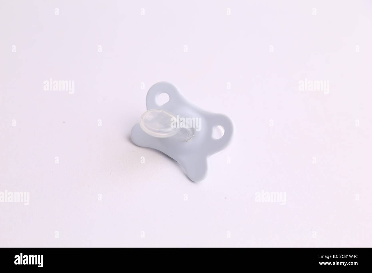 Closeup of a plain white baby pacifier isolated on a white background ...