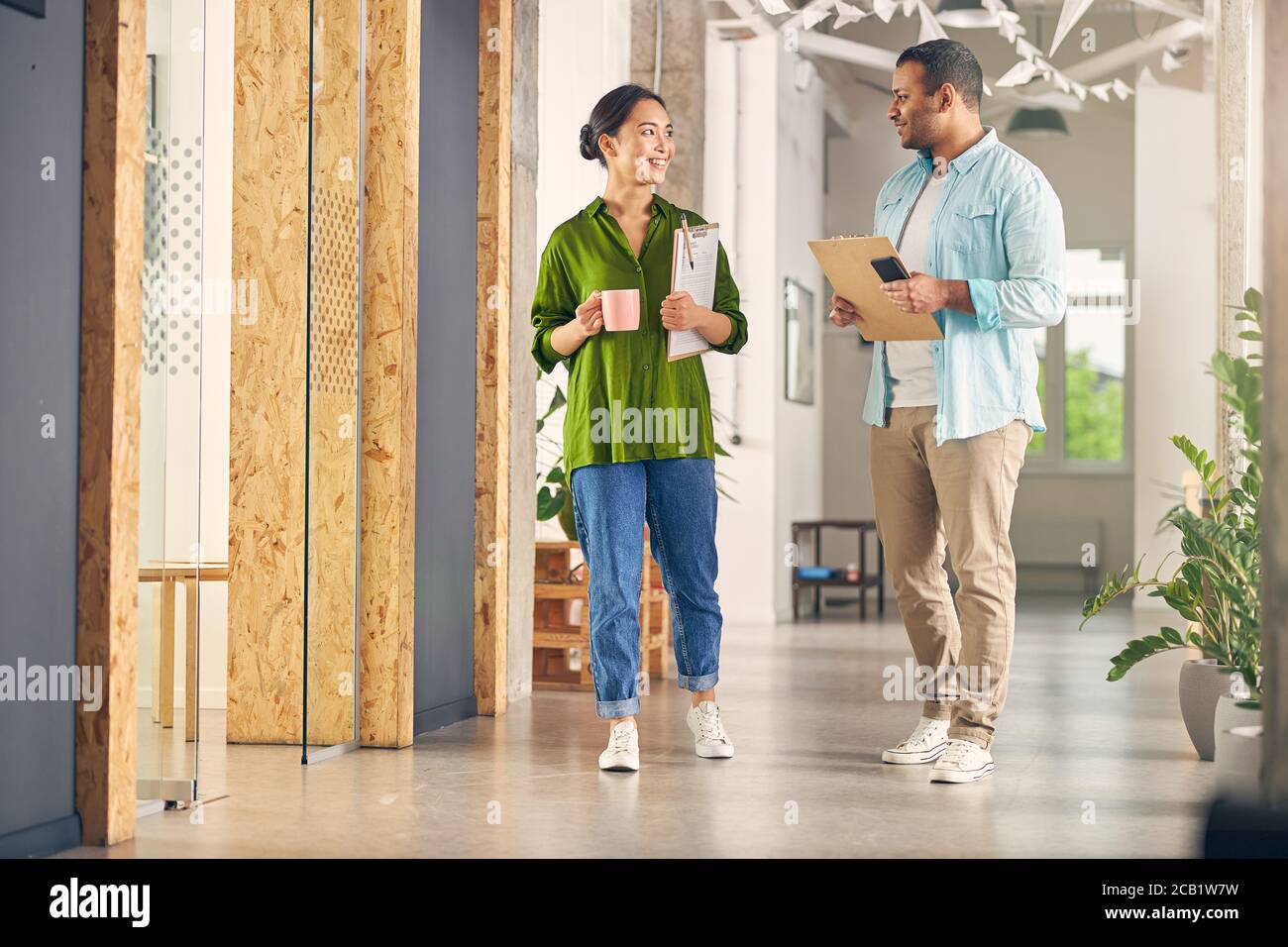 Two international young people having pleasant communication Stock ...