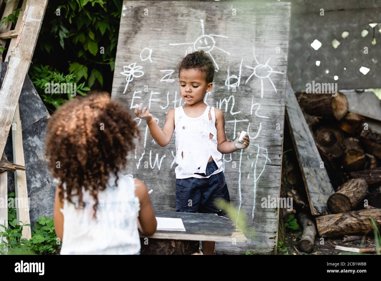 Children stand near table hi-res stock photography and images - Alamy